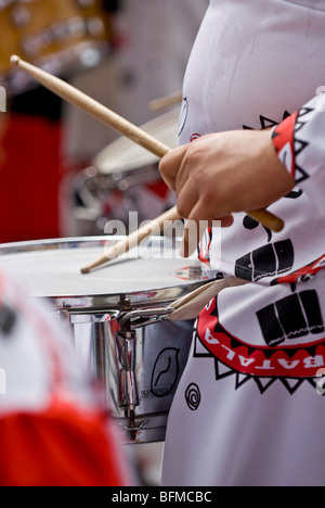 Samba drummers are performing on the street during the parade of the ...
