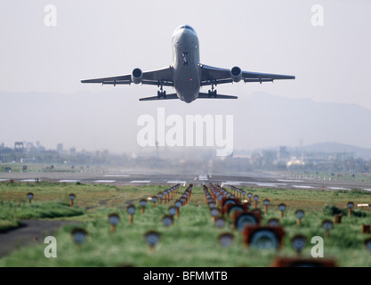 Low angle view of airplane taking off with cloudy sky at background ...