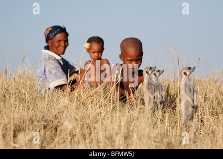 Botswana, Makgadikgadi. Bushmen children play in the dry grasses of ...