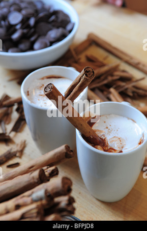 Hot chocolate in mugs on wooden background, top view Stock Photo - Alamy