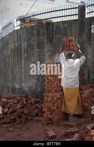 Male worker building pile foundation for wooden frame house. Man ...