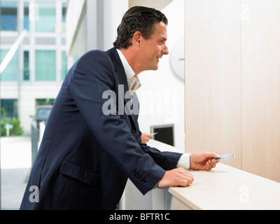 Person smiling with a card on the front of his mouth with a red lips on ...