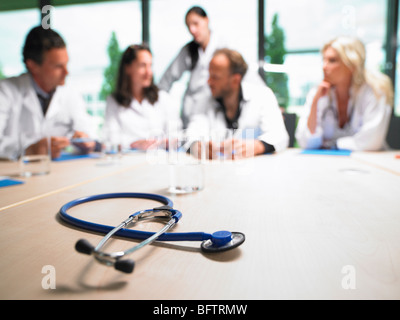 Doctors around a table Stock Photo - Alamy