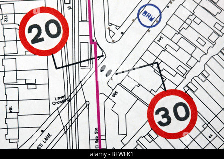 30 and 20 mph zone speed limit signs on a road junction in England ...