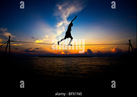 Street performer Will Soto performs his tightrope act during the Sunset ...