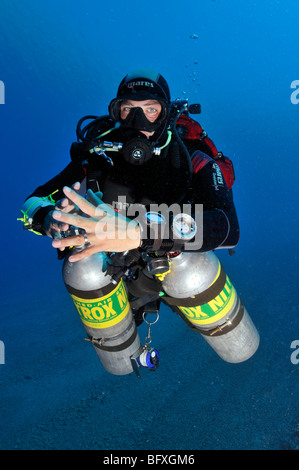 Technical scuba diver with multiple cylinders in shallow water, "Red ...