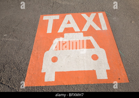 Taxi sign painted on the street floor Stock Photo - Alamy