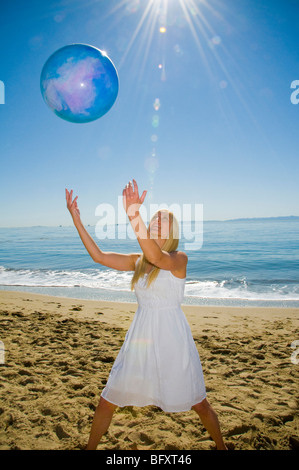 One beach ball in air on white background Stock Photo - Alamy