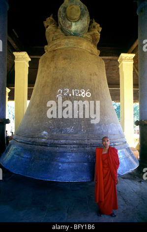 Buddhist monk ringing a large bell at Wat Bo Temple in Siem Reap ...