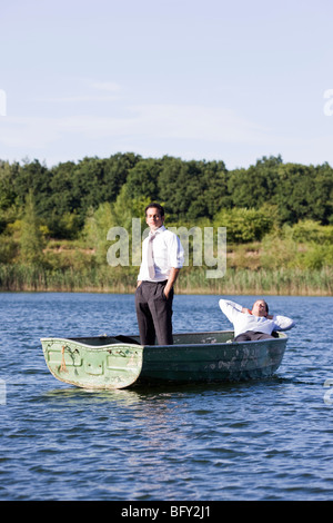 two businessmen relaxing in rowboat Stock Photo - Alamy
