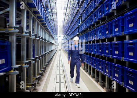 Workman Walking In Front Of A Large Screen With A Projected Image Of A ...