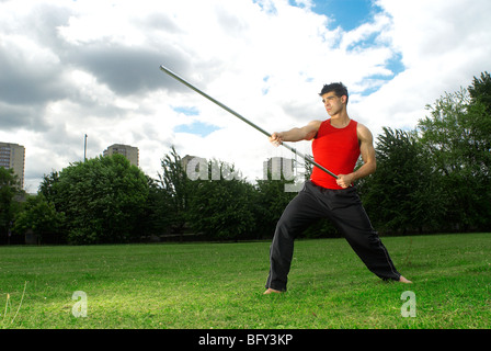 man posing with bow staff Stock Photo - Alamy