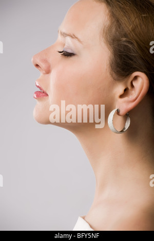 Profil portrait of a beautiful young woman who is sprinkled. Focus is ...
