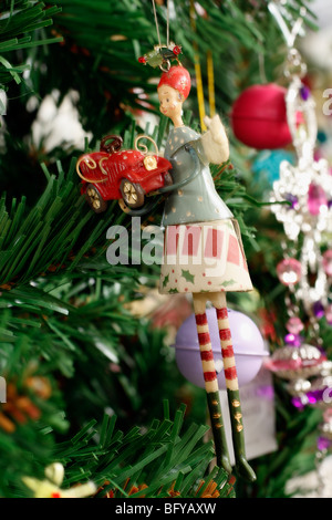 A red car with Christmas decorations and a Christmas tree is standing ...