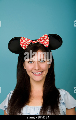 Woman wearing mouse ears and looking excited Stock Photo - Alamy