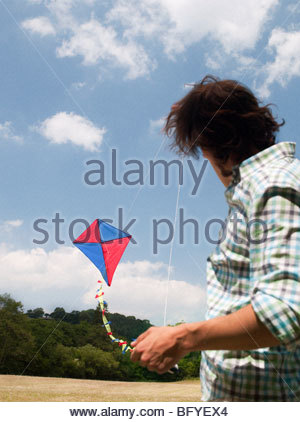 A young man flying a power kite in high winds on moorland east of Stock ...