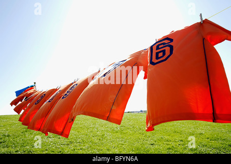football dresses hanging on clothesline Stock Photo - Alamy