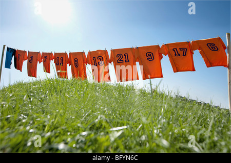 football dresses hanging on clothesline Stock Photo - Alamy