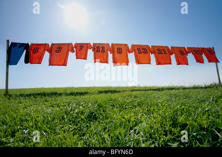 football dresses hanging on clothesline Stock Photo - Alamy