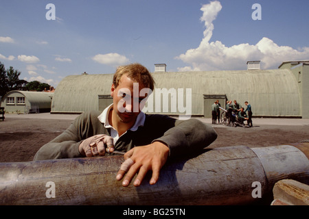 Fleet Air Arm field gun crew gather around their spare gun after their ...