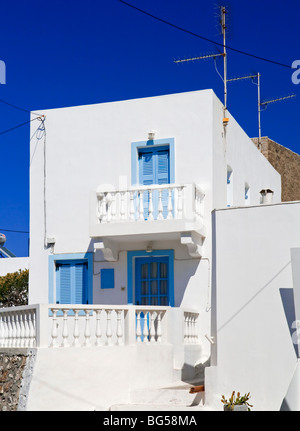 typical greek house with white walls and blue windows on Santorini ...