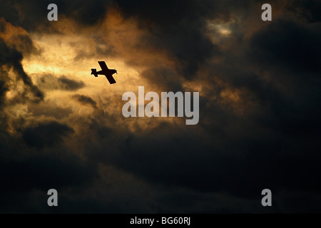 Small plane in stormy sky Stock Photo - Alamy