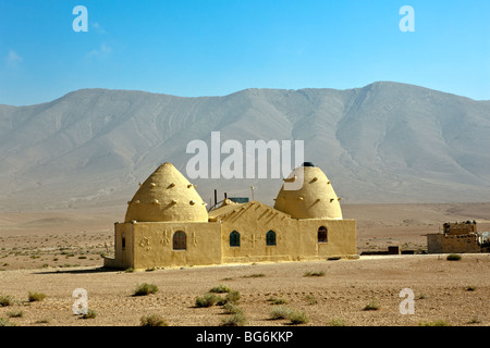 Traditional Syrian "beehive" house in the desert beside the road ...