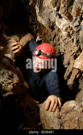 Cave explorer up in the hole with ladder Stock Photo - Alamy