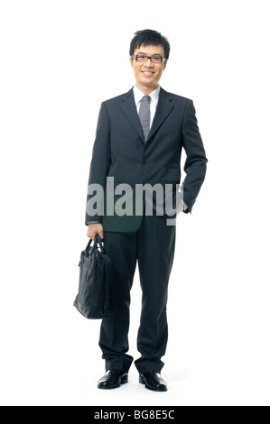 Full length of businessman carrying bag while walking on street Stock ...