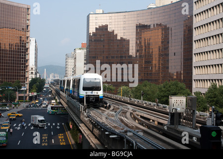 An Innovia APM 256 train traveling on elevated rails approaches the ...