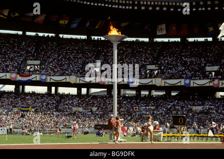Olympic torch stands above an athletic field holding events Stock Photo ...