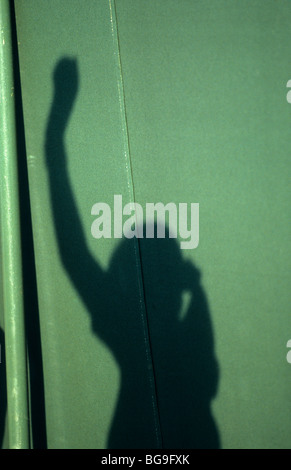 Shadow of a ball girl holding up a tennis ball Stock Photo - Alamy