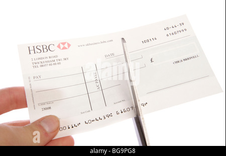 Cheque being cut up studio cutout Stock Photo - Alamy