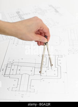 Hand of the engineer with compasses - work with drawings Stock Photo ...