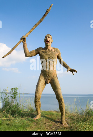 Primitive hunters on the shore of the blue sea Stock Photo - Alamy