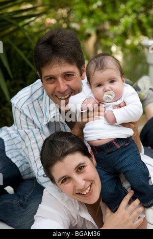 Portrait of young family with newborn baby boy cuddling in bed Stock ...