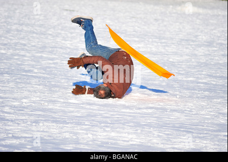 Man falling off a sledge Stock Photo - Alamy