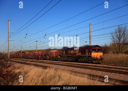 An EWS class 66 diesel pulling an empty car train, Northamptonshire, UK ...