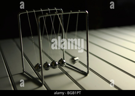 five metal balls hanging from nylon string Stock Photo - Alamy