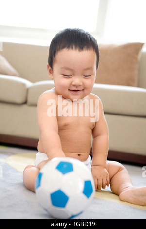Chinese baby boy with a soccer ball in grass, shot in Beijing, China ...