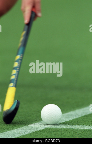 man hand holding a hockey stick against the sky, abstract sport ...