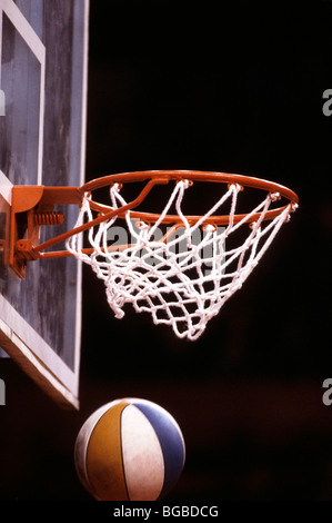 Basketball dropping through the net Stock Photo - Alamy
