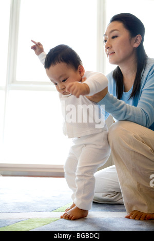 Baby development walking at home indoors. One year old toddler infant ...