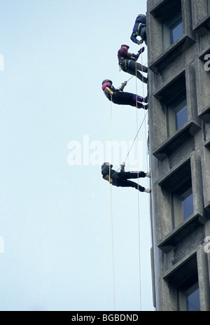 Three men abseiling a building Stock Photo - Alamy
