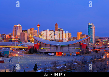 The Saddledome with high-rise buildings and the Calgary Tower in the ...