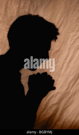 Shadow of man worship with hands raised to the sky in nature Stock ...