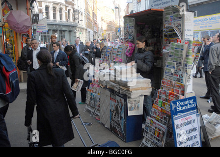London newspaper vendor distributing free newspapers on High Holborn ...