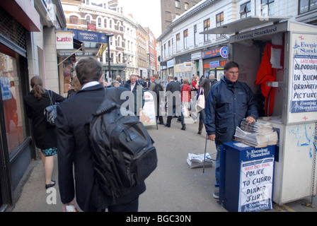 London newspaper vendor distributing free newspapers on High Holborn ...