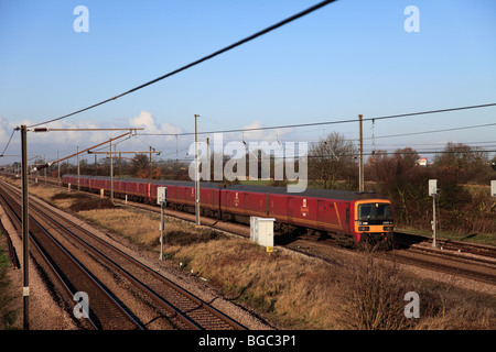 Royal Mail Class 325 parcels train at speed, passing Oxenholme Rail ...