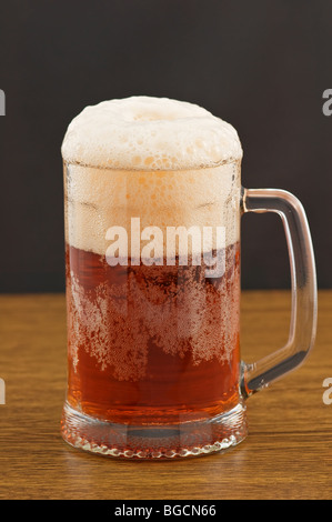 red beer with the foam in mug isolated on white Stock Photo - Alamy